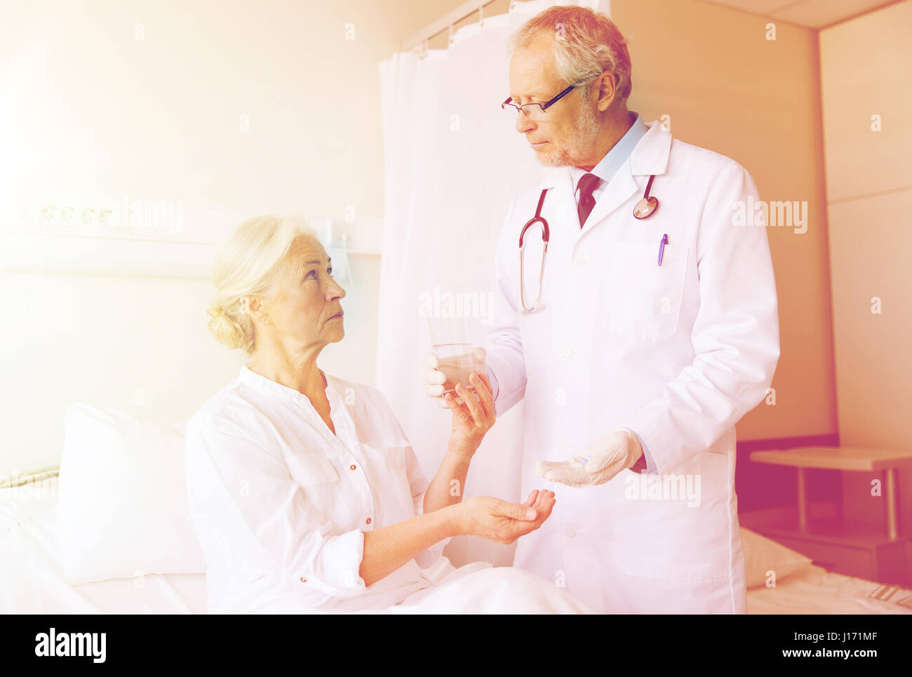 doctor giving medicine to senior woman at hospital Stock Photo - Alamy
