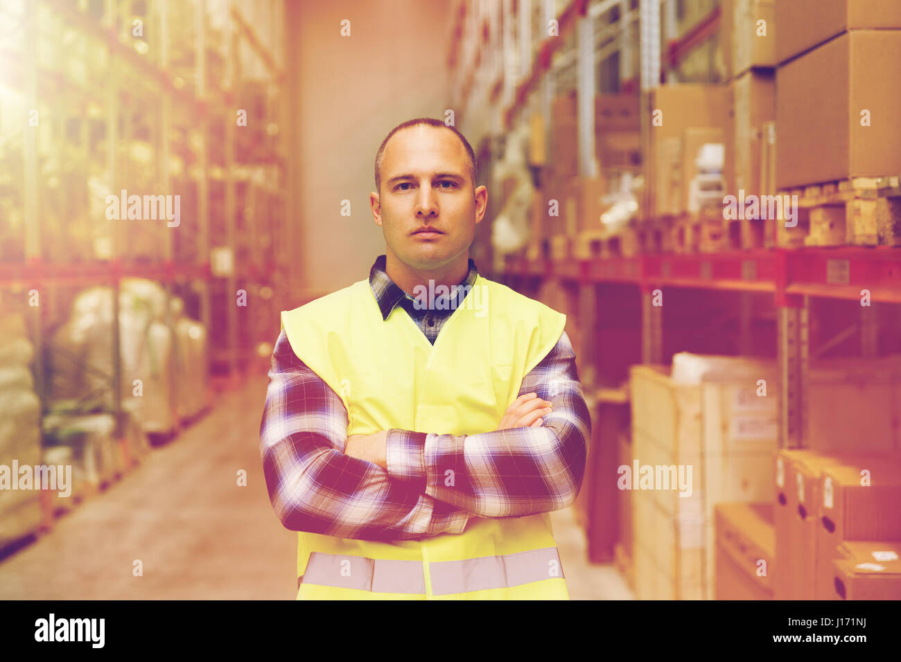 man in reflective safety vest at warehouse Stock Photo - Alamy