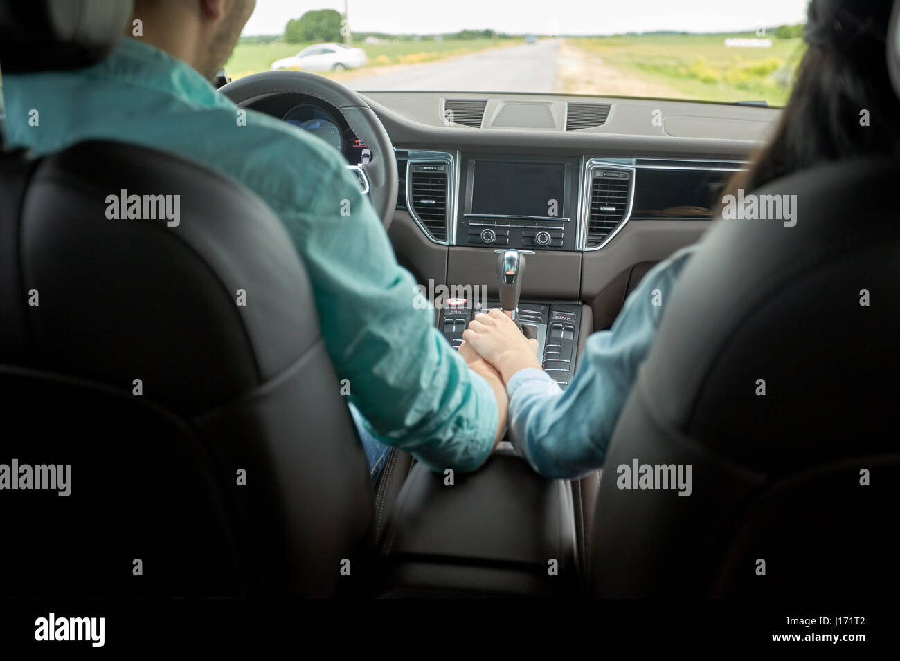 happy couple driving in car and holding hands Stock Photo - Alamy