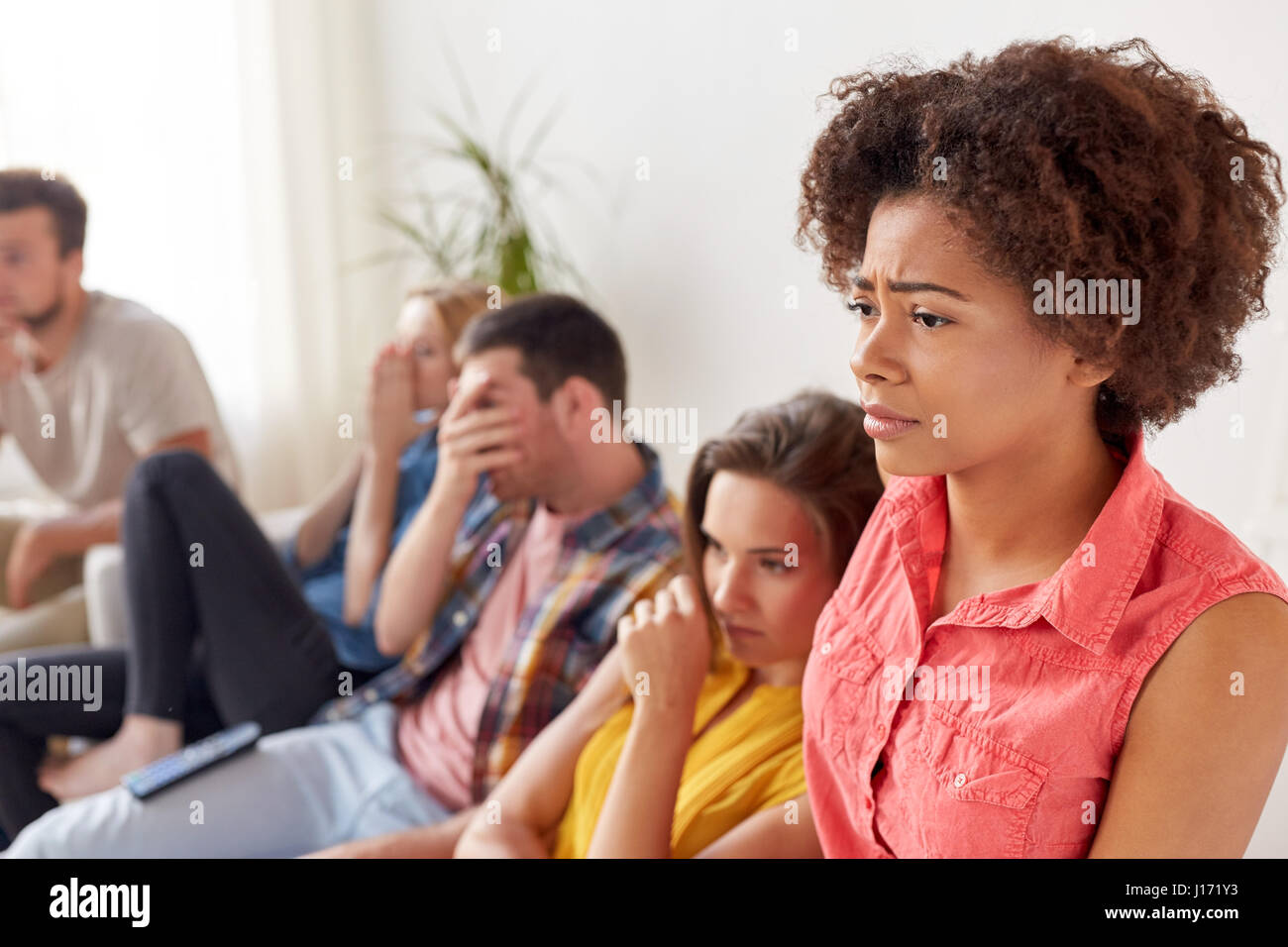 sad friends watching tv at home Stock Photo - Alamy