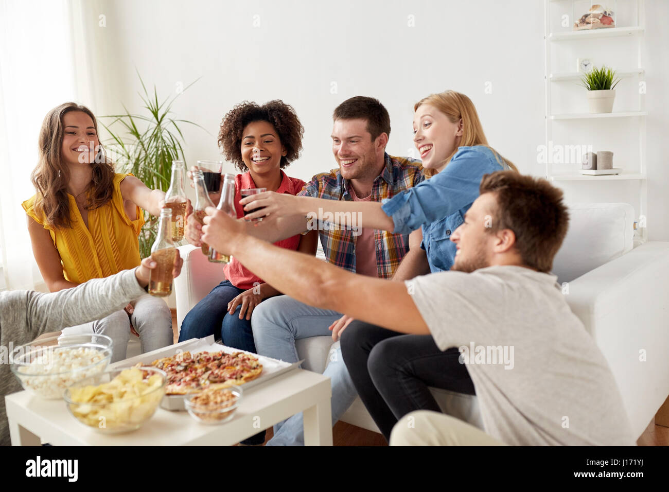 friends having party and clinking drinks at home Stock Photo - Alamy