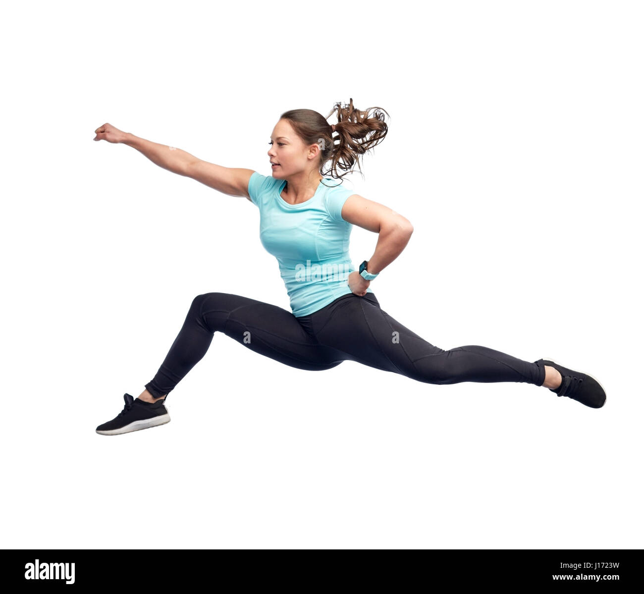 happy sporty young woman jumping in fighting pose Stock Photo - Alamy
