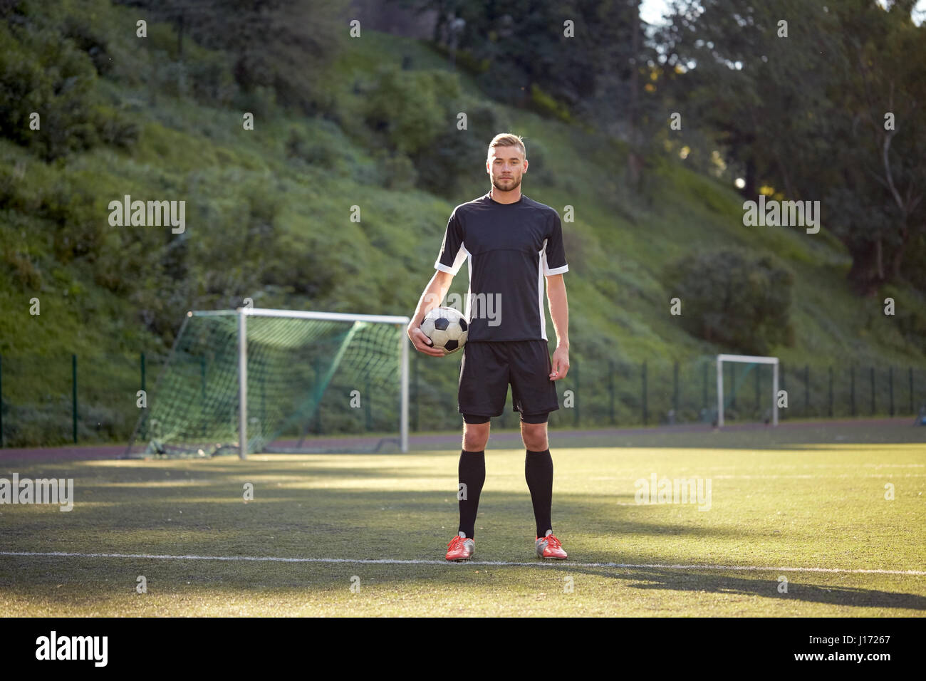 soccer player with ball on football field Stock Photo - Alamy