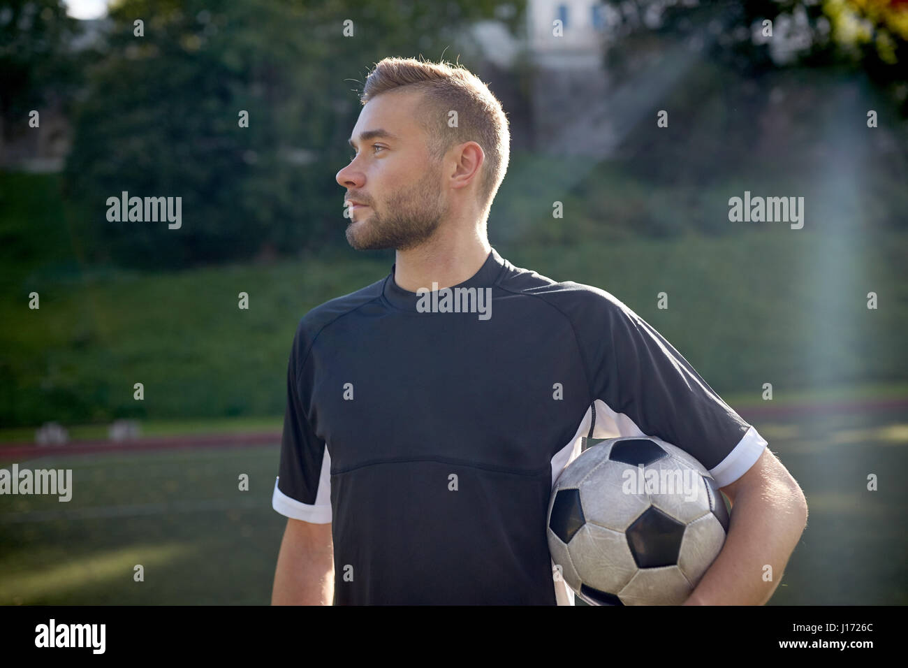 soccer player with ball on football field Stock Photo - Alamy
