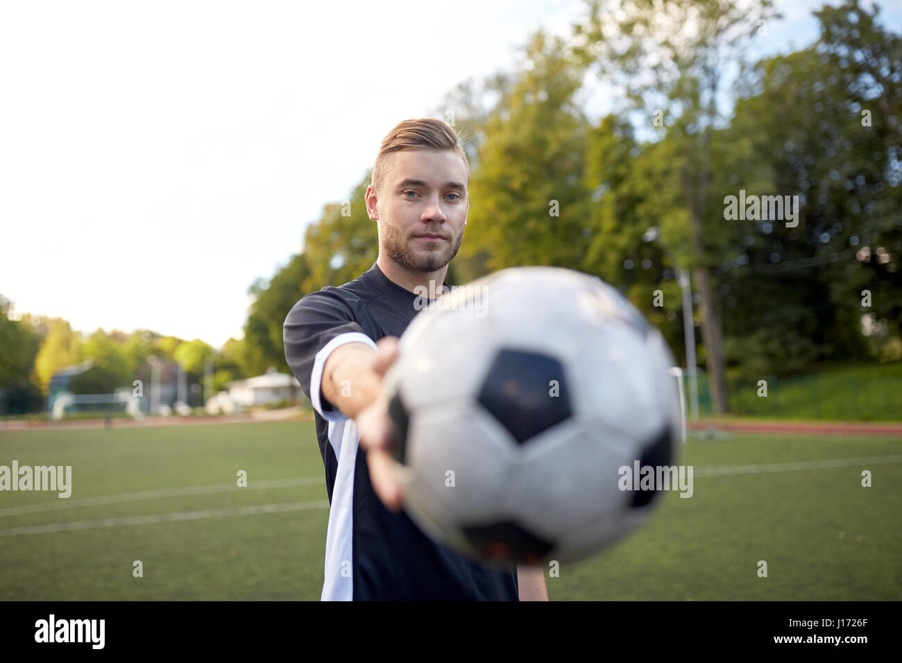 soccer player with ball on football field Stock Photo - Alamy
