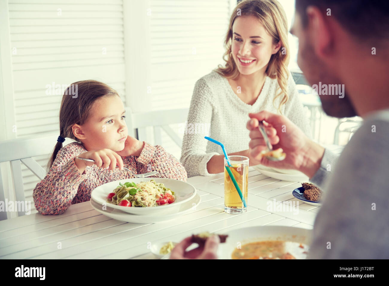happy family having dinner at restaurant or cafe Stock Photo - Alamy