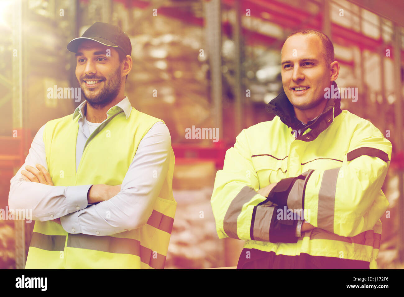 smiling men in reflective uniform at warehouse Stock Photo - Alamy