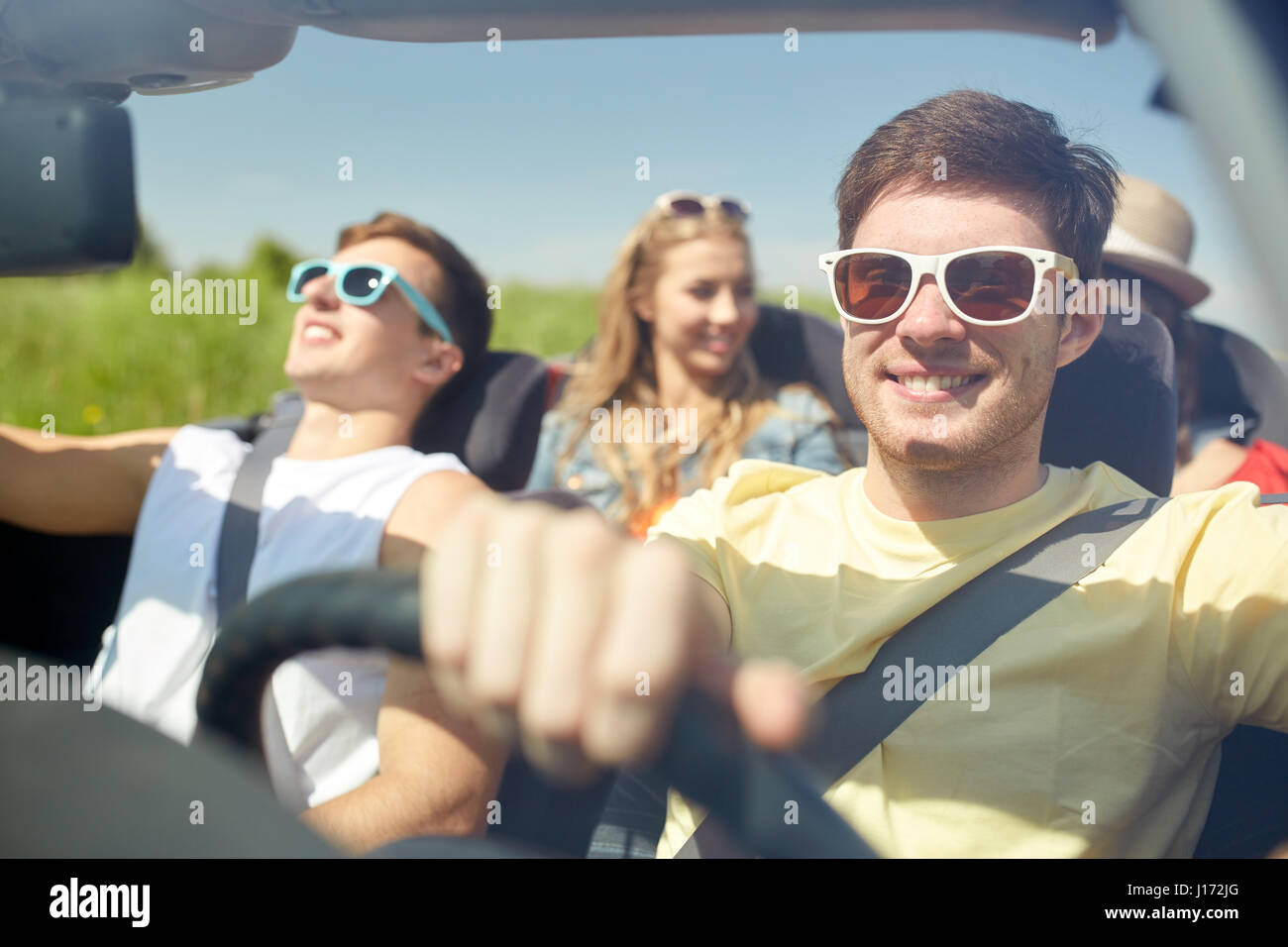 happy friends driving in cabriolet car Stock Photo - Alamy