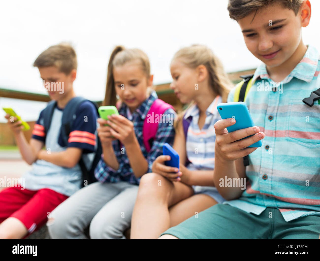 elementary school students with smartphones Stock Photo - Alamy
