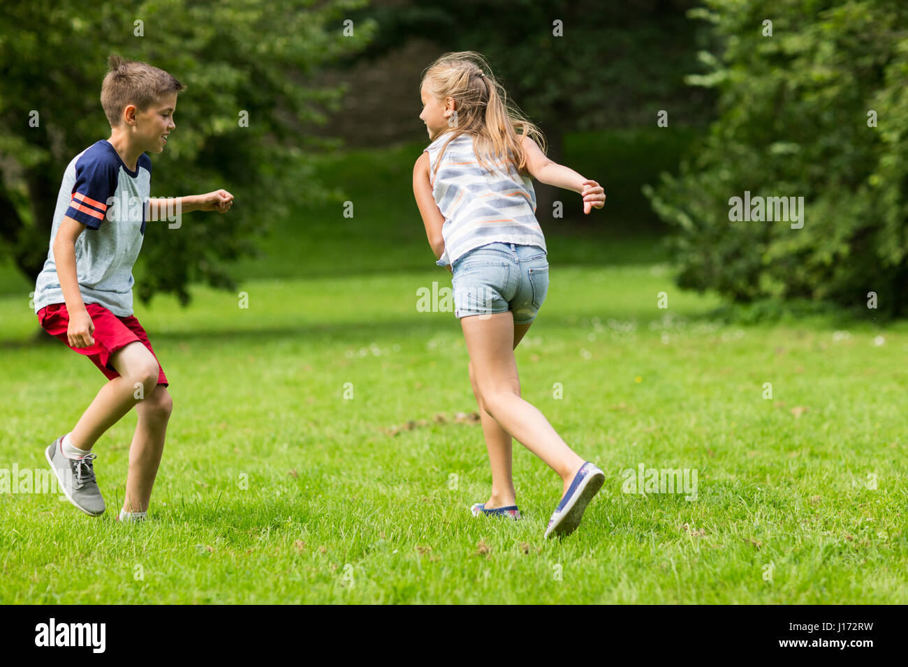 group of happy kids or friends playing outdoors Stock Photo - Alamy