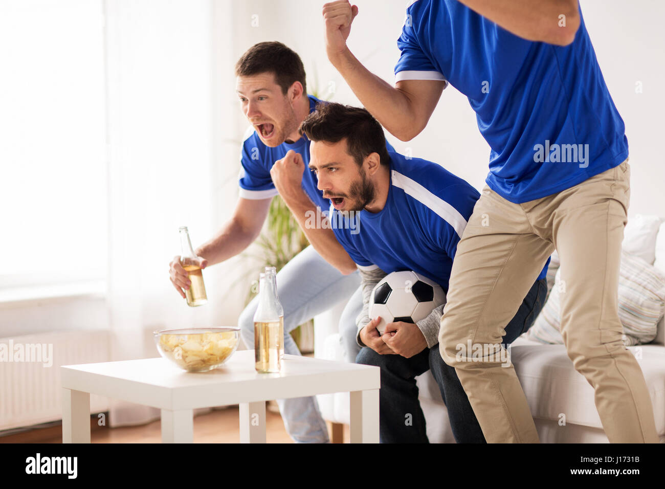 Friends winning table football hi-res stock photography and images - Alamy