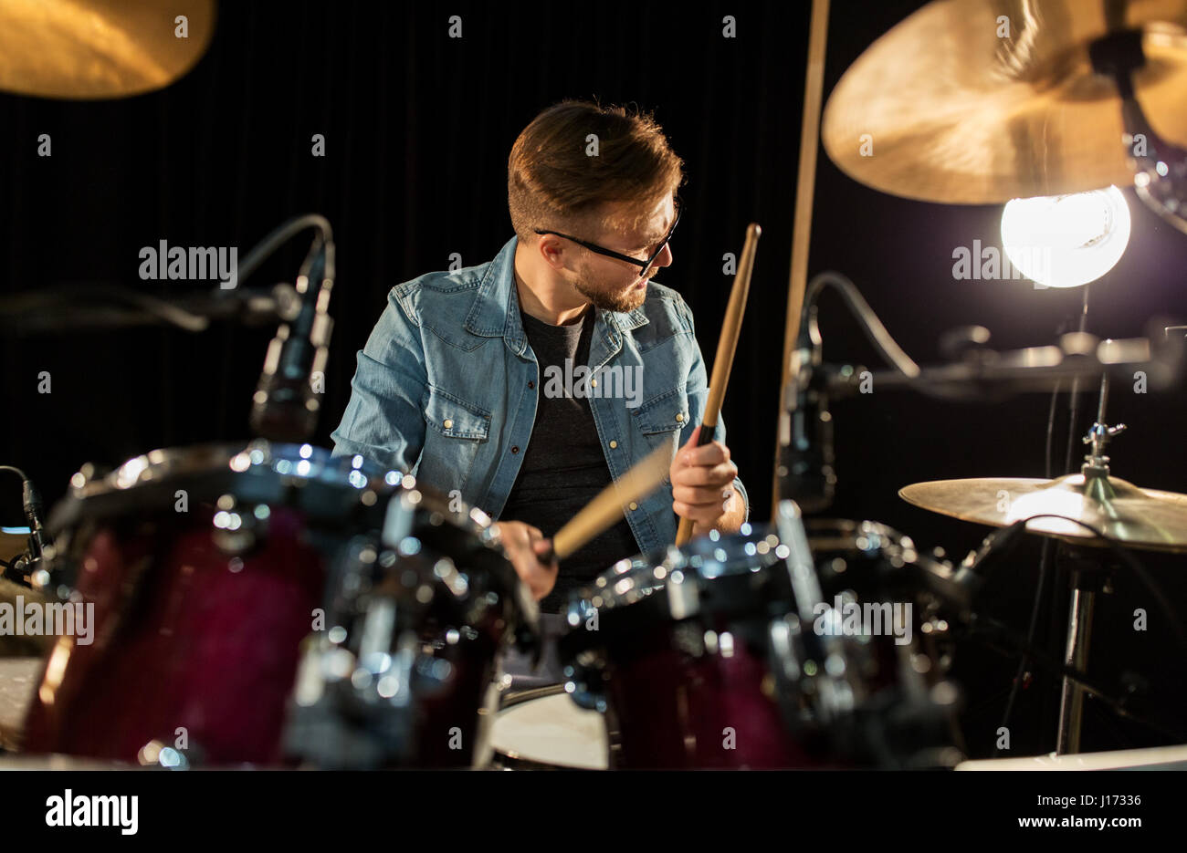 male musician playing drums and cymbals at concert Stock Photo - Alamy
