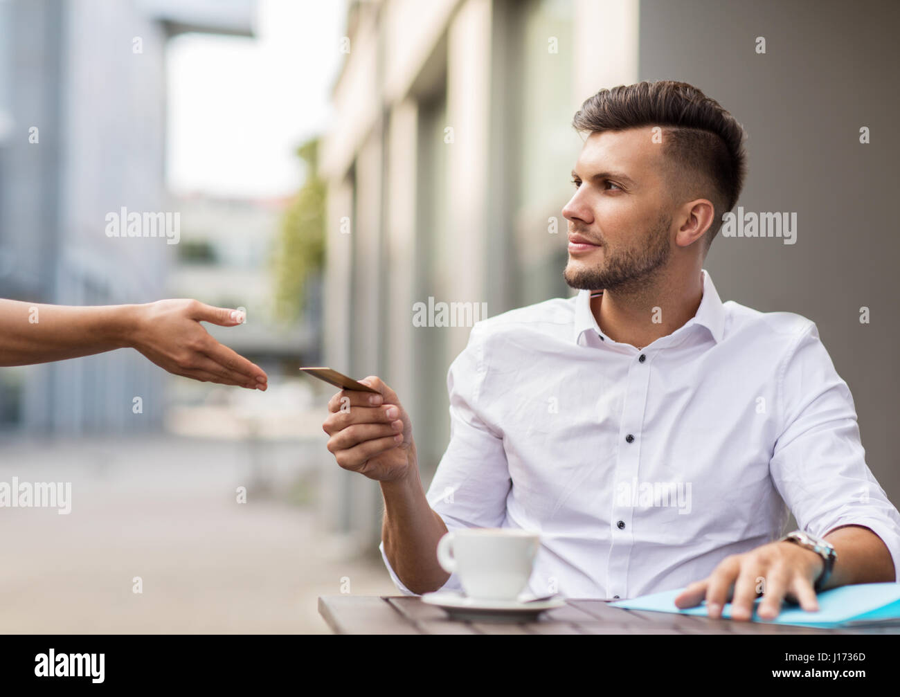 man with credit card paying for coffee at cafe Stock Photo - Alamy