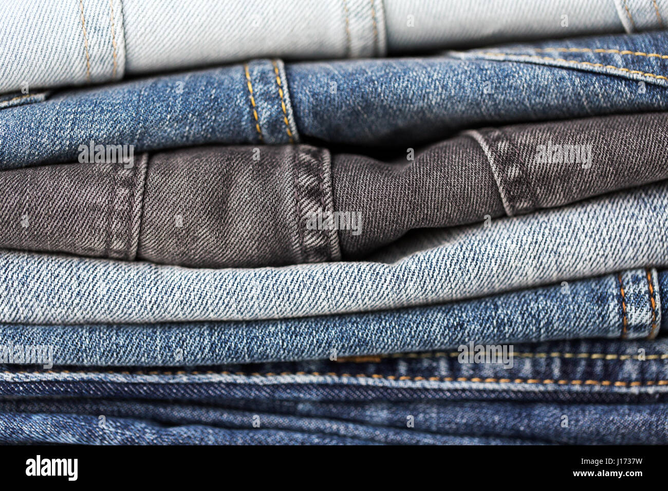 close up of denim clothes or jeans pile Stock Photo - Alamy