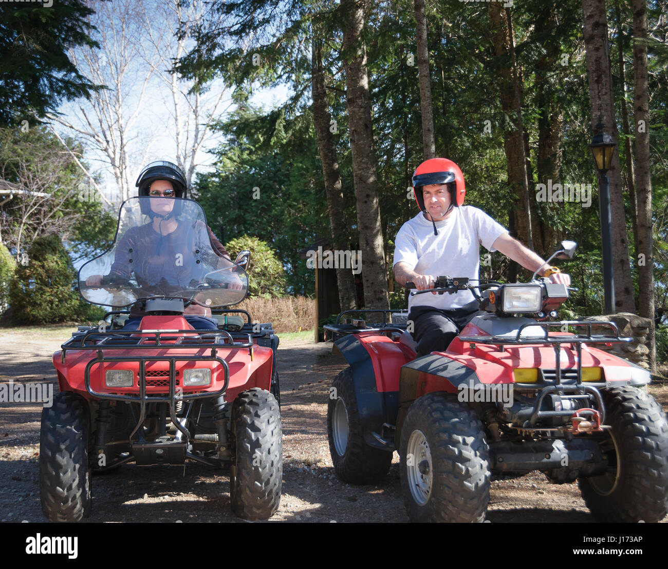 young couple riding a quad vehicle Stock Photo - Alamy