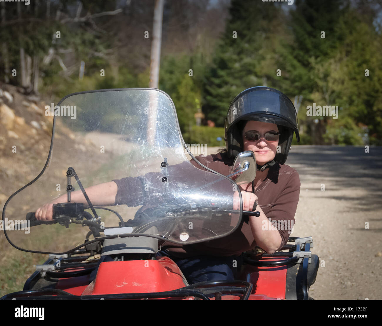 young woman riding a Quad in Quebec rural road, Canada Stock Photo - Alamy