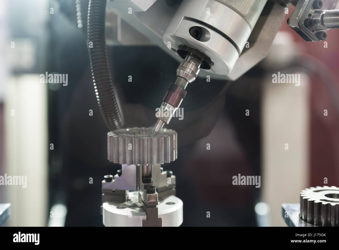 The five-axis Computer Numerical Control (CNC) machine while cutting ... The five-axis Computer Numerical Control (CNC) machine while cutting ...