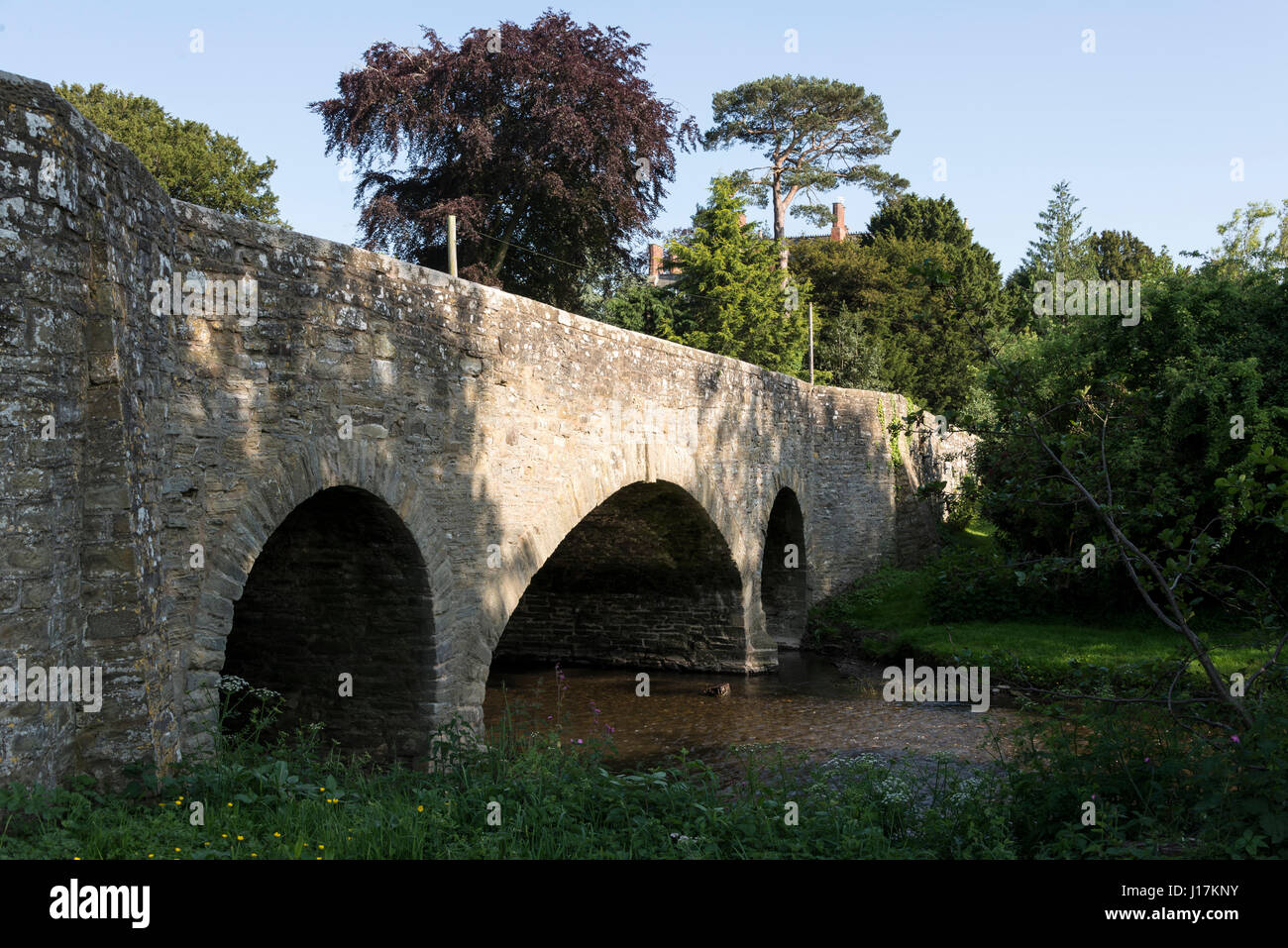 A centuries old bridge over the River Arrow in Pembridge village in ...