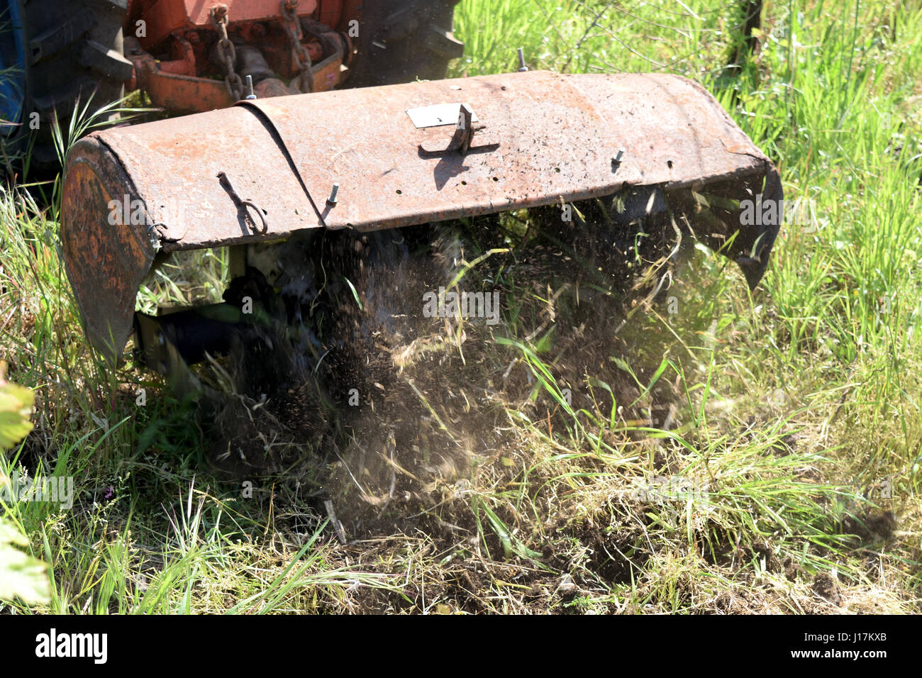 plowing of the soil with old rotary hoe Stock Photo - Alamy