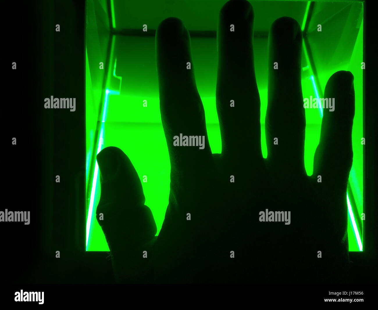 A man uses a fingerprint scanner for identification. Can be used for ...