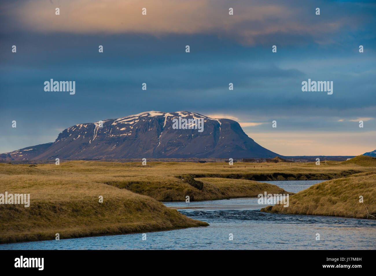 Icelandic spring landscape with snowcapped mountains in the distance ...