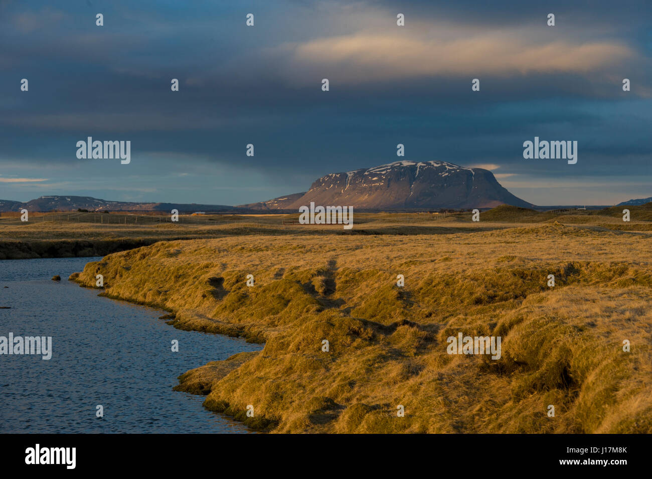 Icelandic spring landscape with snowcapped mountains in the distance ...