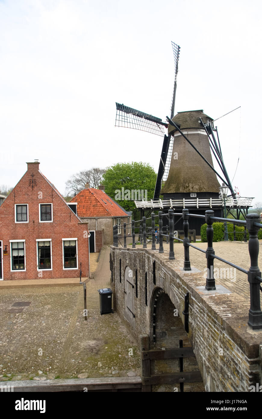 windmill and stone bridge in Sloten, Gaasterland, Friesland, Holland ...