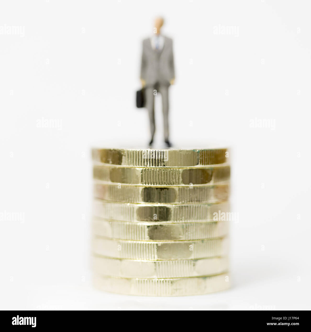 Close up/macro model stock photo depicting male wage worker on stack of ...