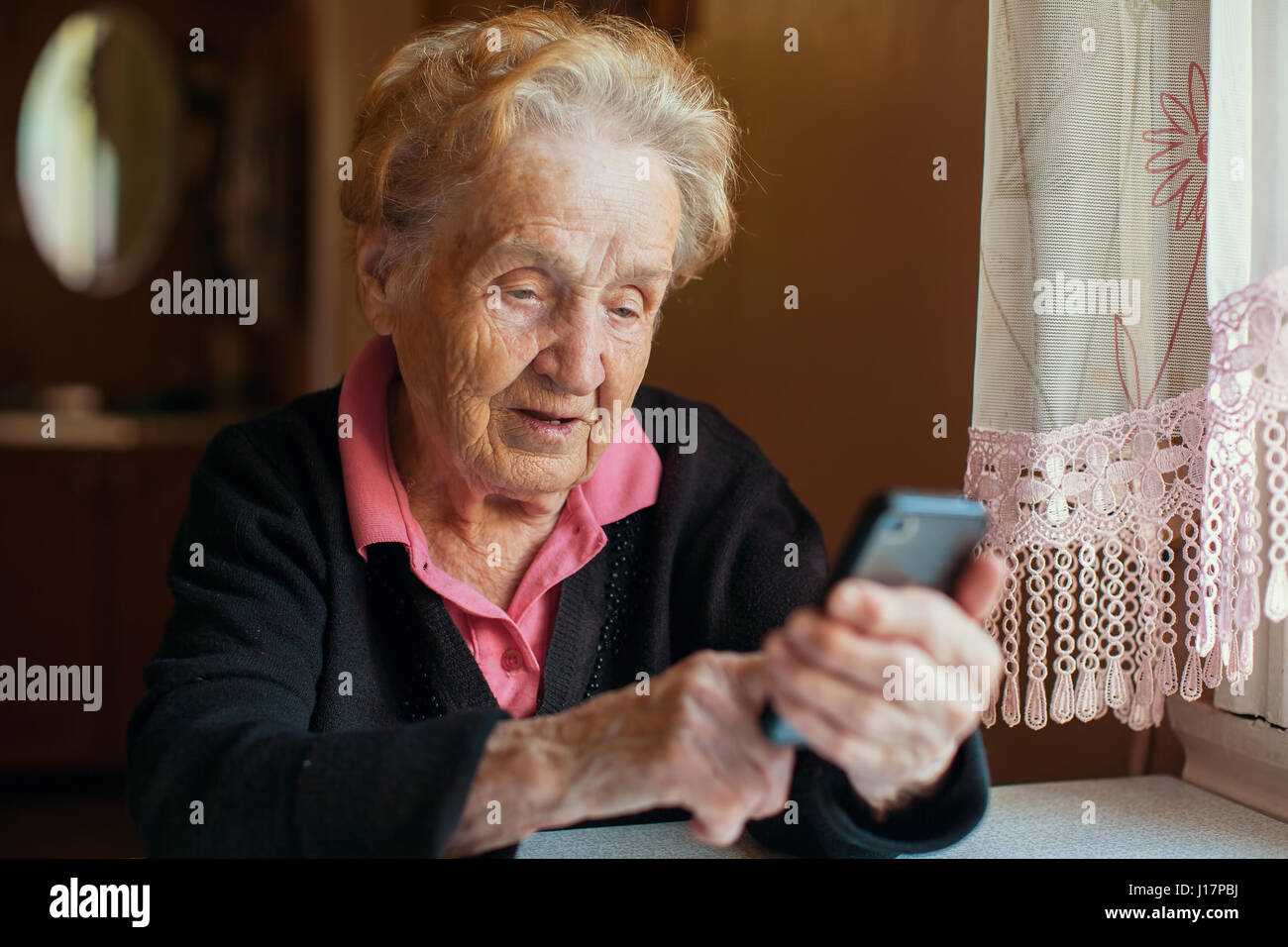 An old woman uses a smart phone Stock Photo - Alamy