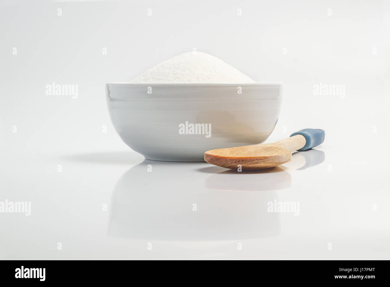 Bowl filled with sugar in white reflective surface Stock Photo - Alamy