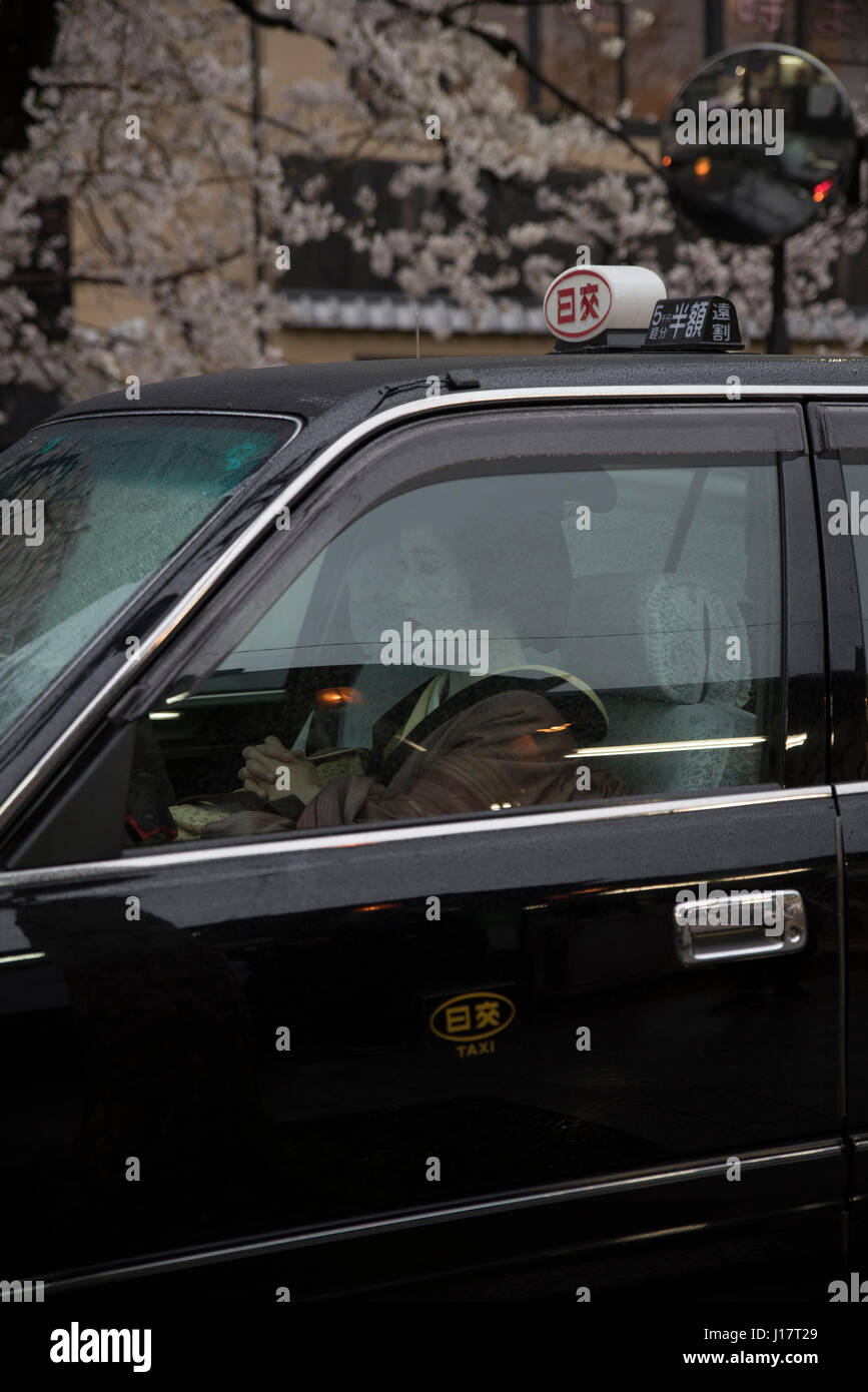 Geisha sitting in taxi on Kiyamachi-dori street in Higashiyama nr. Gion ...