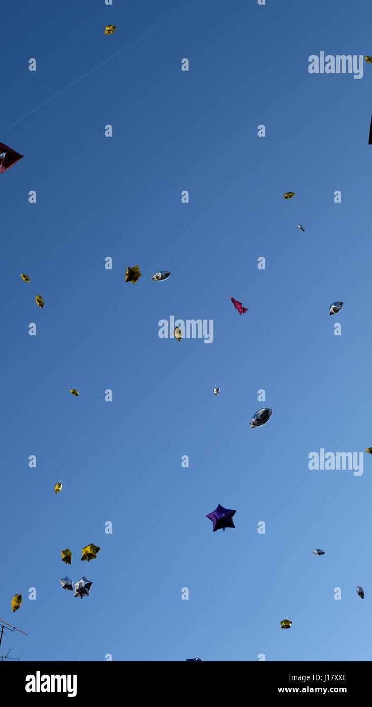 Small star shaped balloons floating in blue sky Stock Photo - Alamy