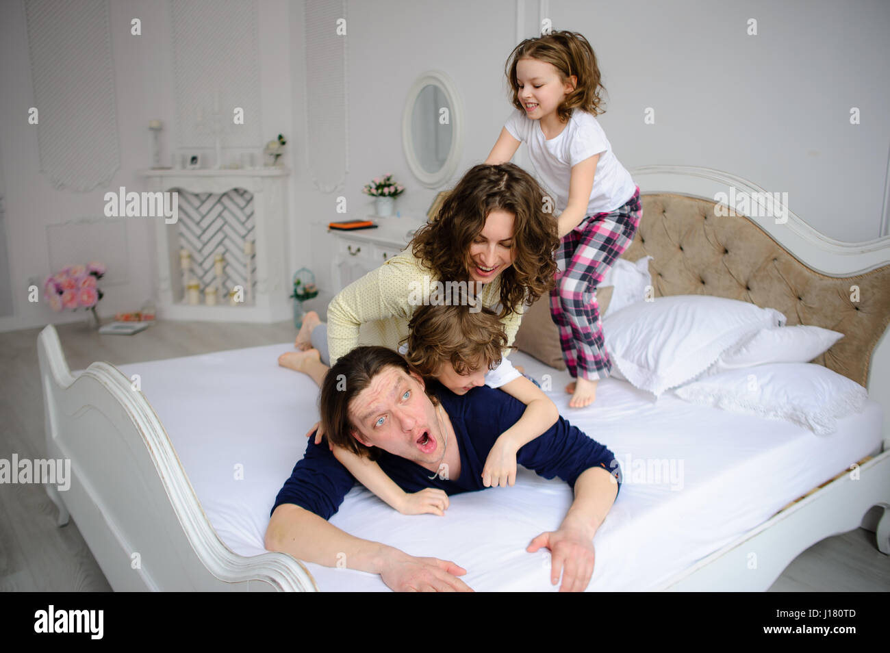 Cheerful beginning of day in a happy family. Mum, daddy and two ...