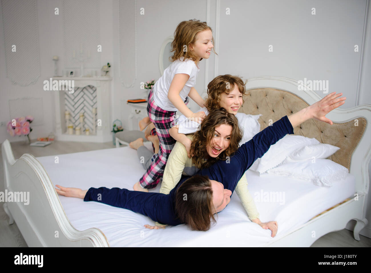 Cheerful beginning of day in a happy family. Mum, daddy and two ...