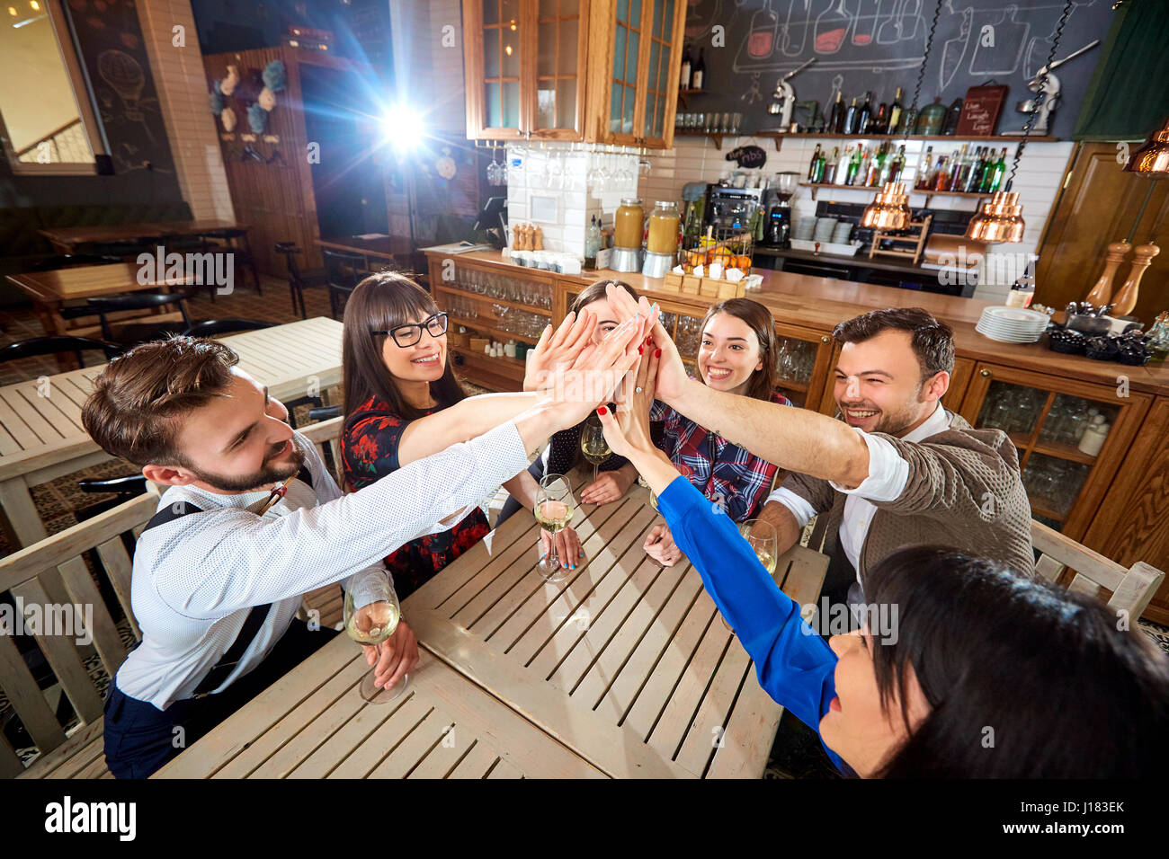 Friends putting their hands up together in a sign of friendship Stock ...