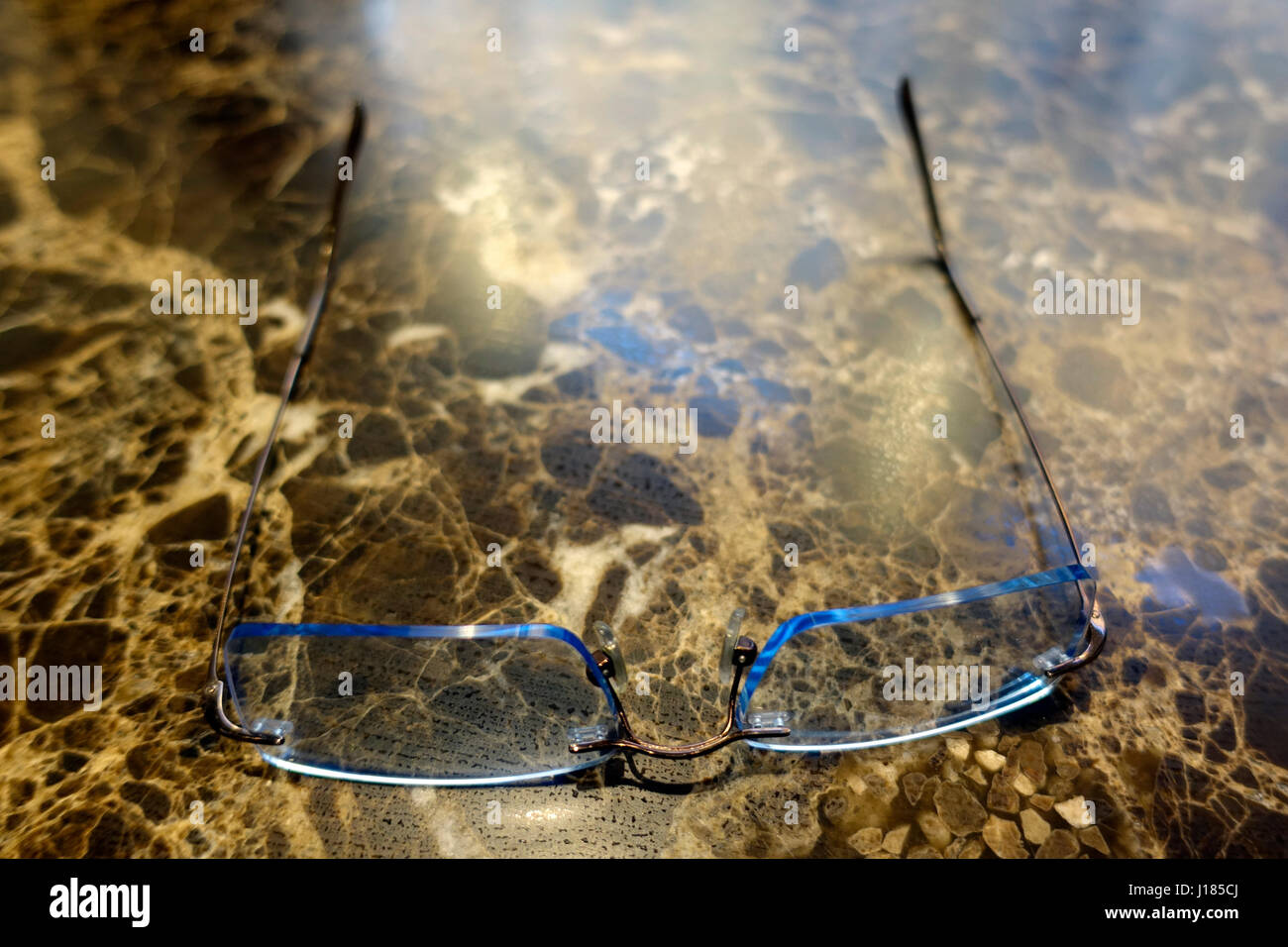 Eyeglasses on table Stock Photo - Alamy