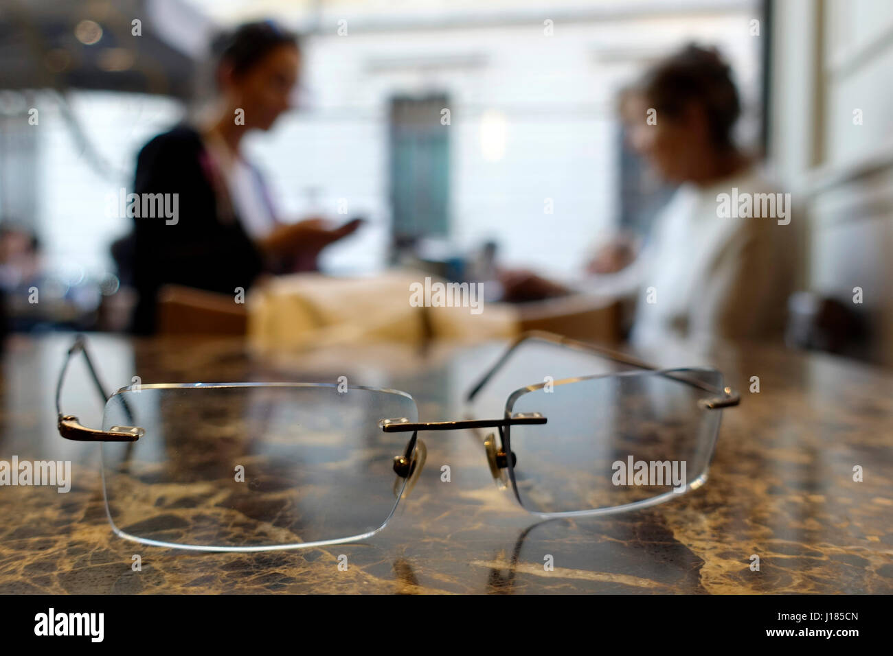 Eyeglasses on table Stock Photo - Alamy