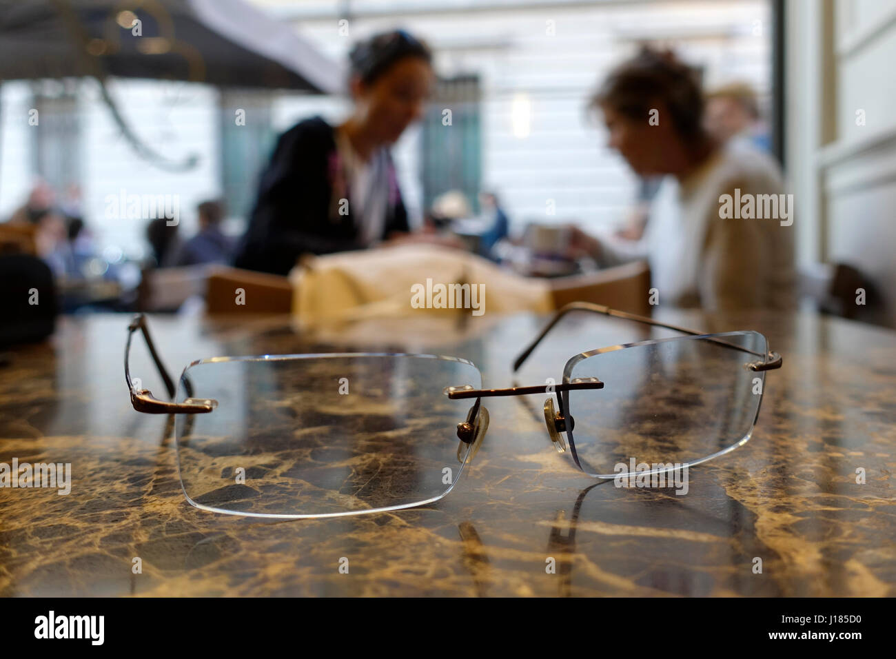 Eyeglasses on table Stock Photo - Alamy