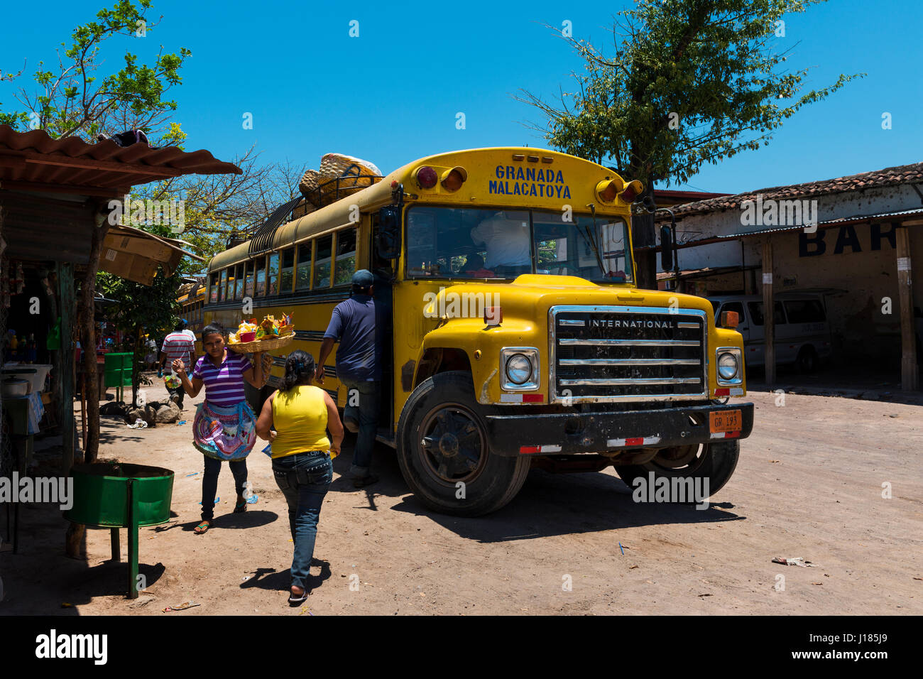 Granada, Nicaragua - April 4, 2014: People entering an old public bus ...