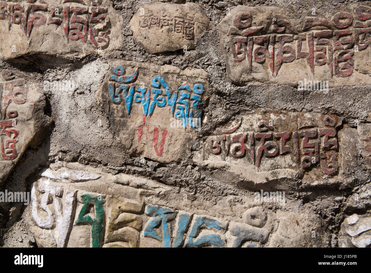 Writing carved on a stone wall Swayambhu / Swayambhunath, Kathmandu ...