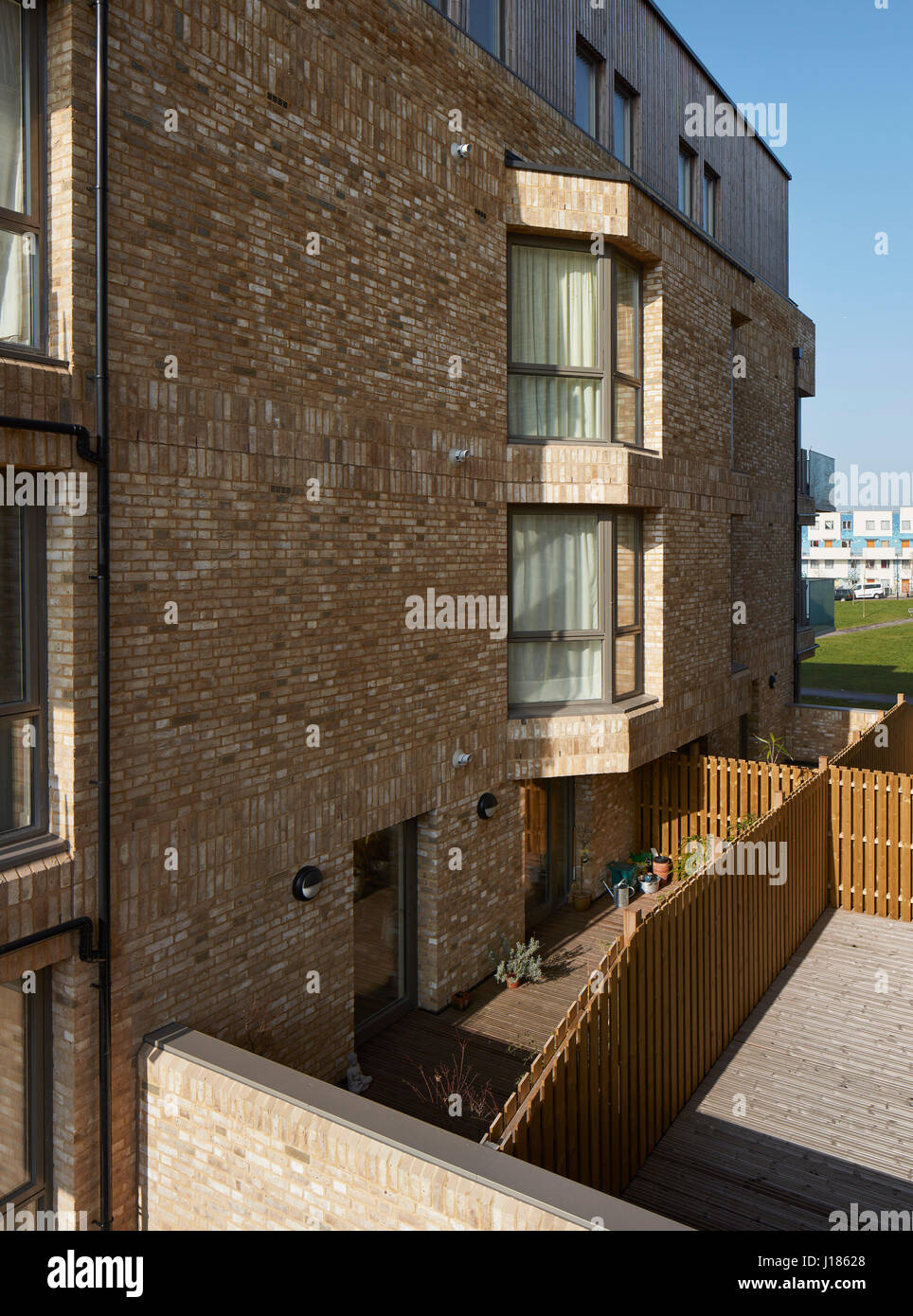 View along modern bay windows of villa apartments. Stonebridge Park ...