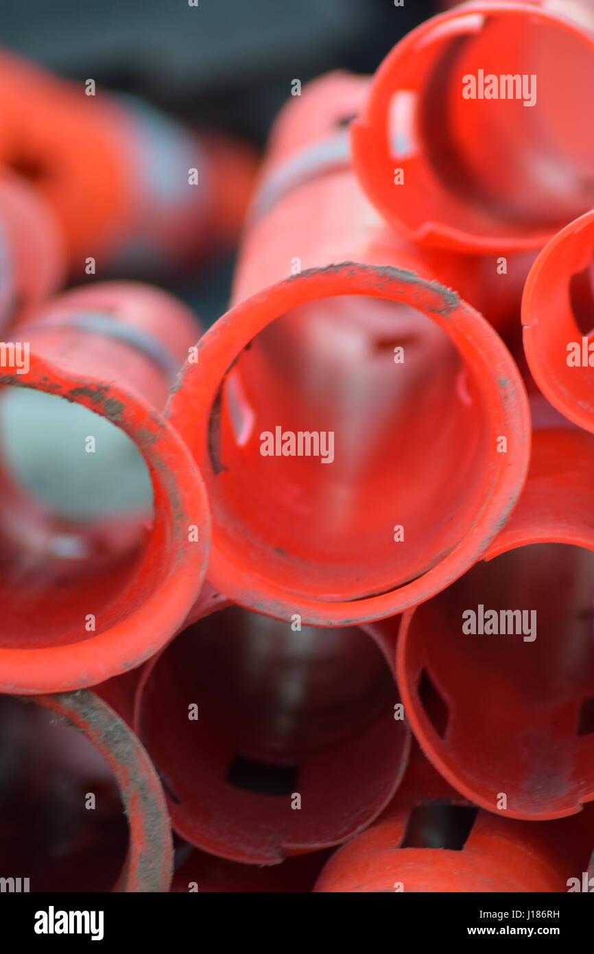 Red cylinder traffic cones stacked Stock Photo - Alamy