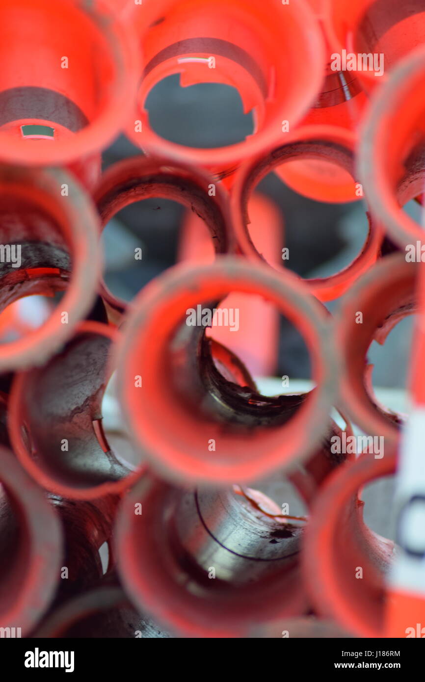 Red cylinder traffic cones stacked Stock Photo - Alamy