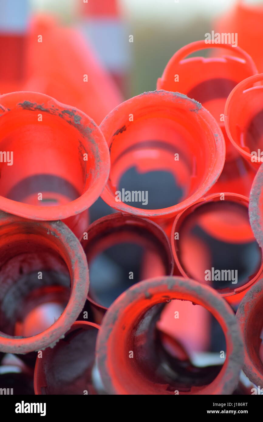 Red cylinder traffic cones stacked Stock Photo - Alamy
