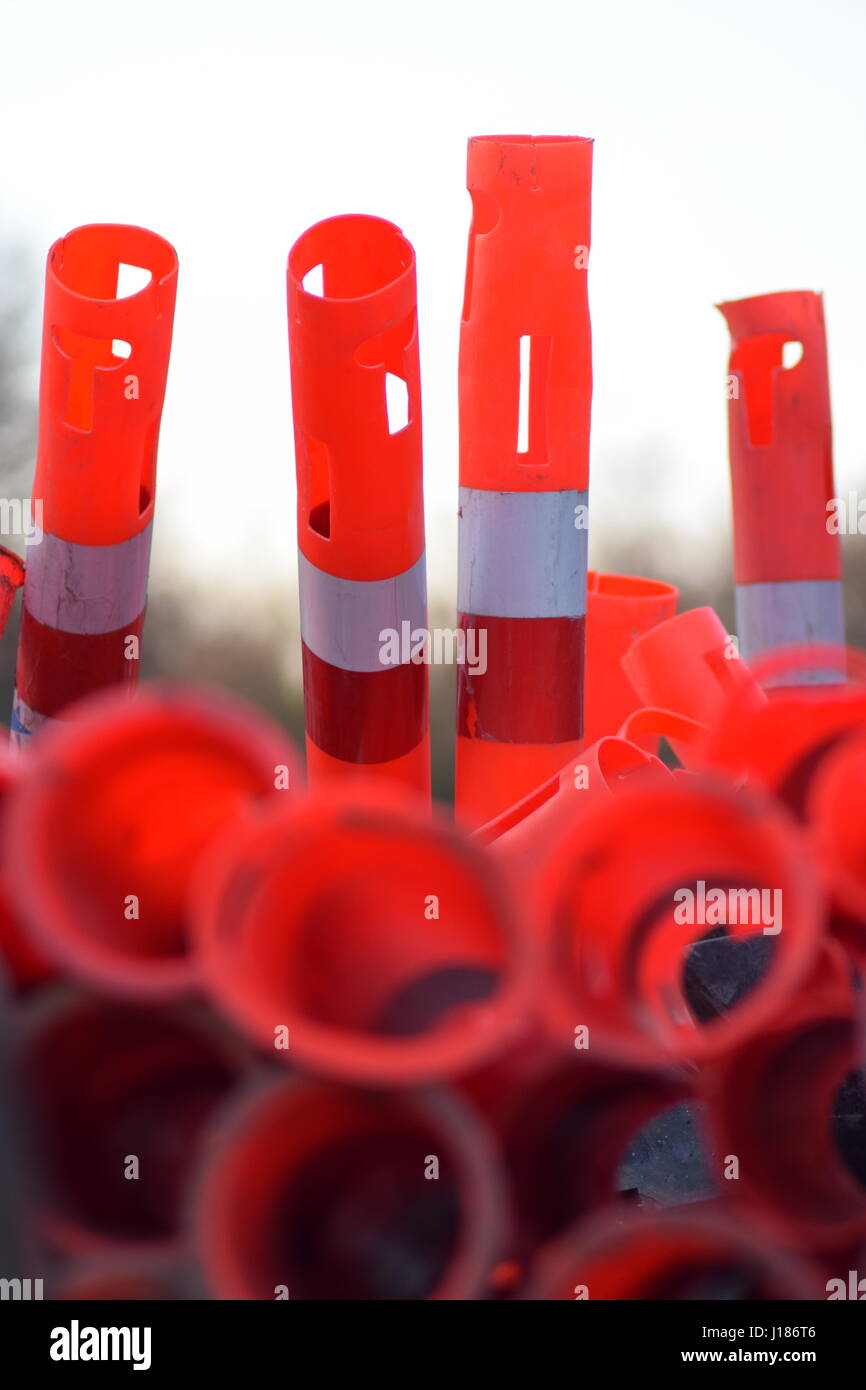 Red cylinder traffic cones stacked Stock Photo - Alamy