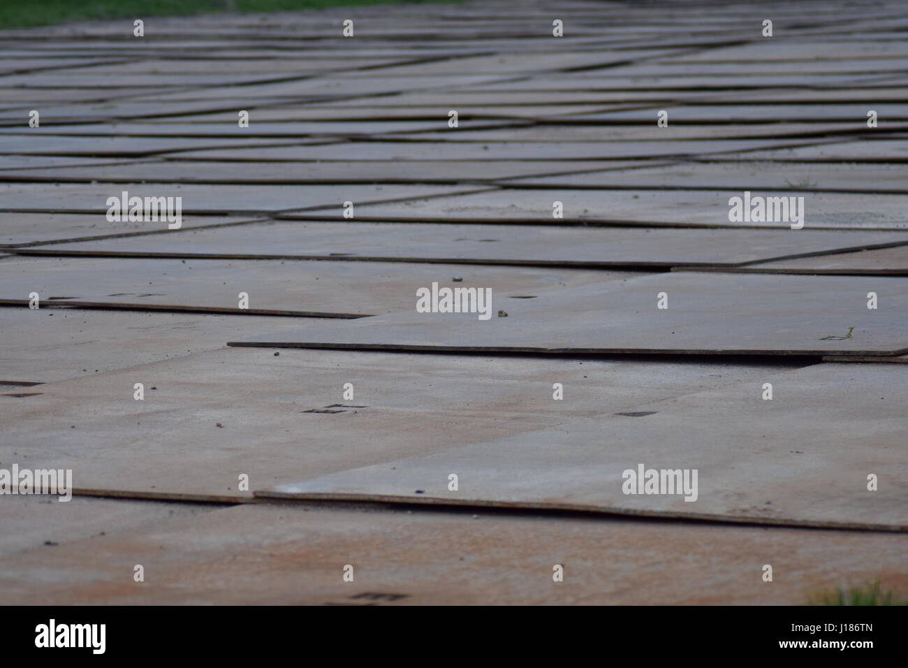 Metal plates laid out on the ground for construction work Stock Photo ...