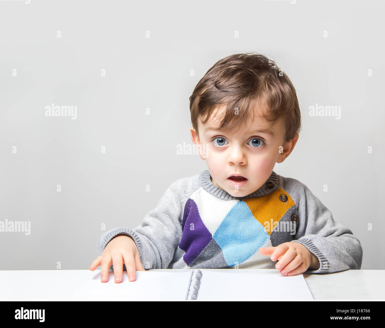 Child looking at the camera with an amazed look Stock Photo - Alamy