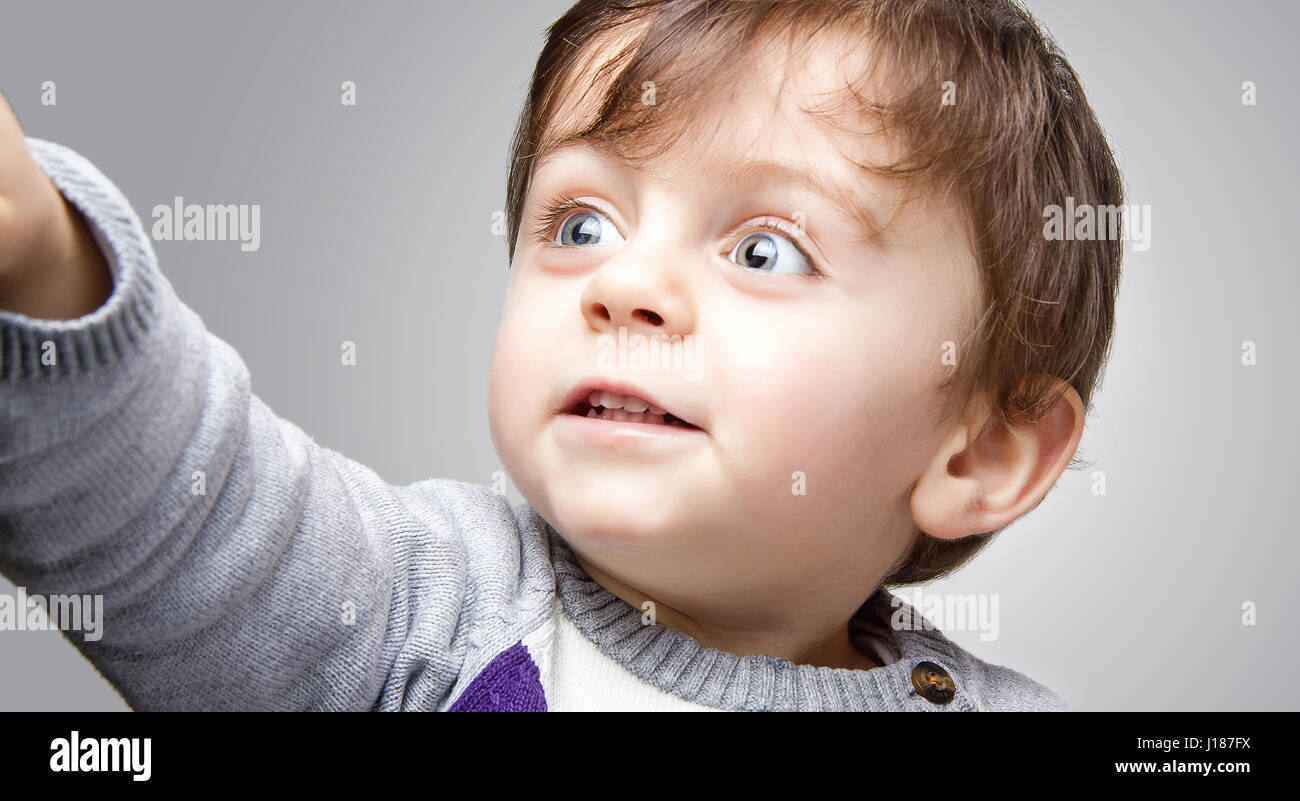 Child looking away from the camera smiling Stock Photo - Alamy