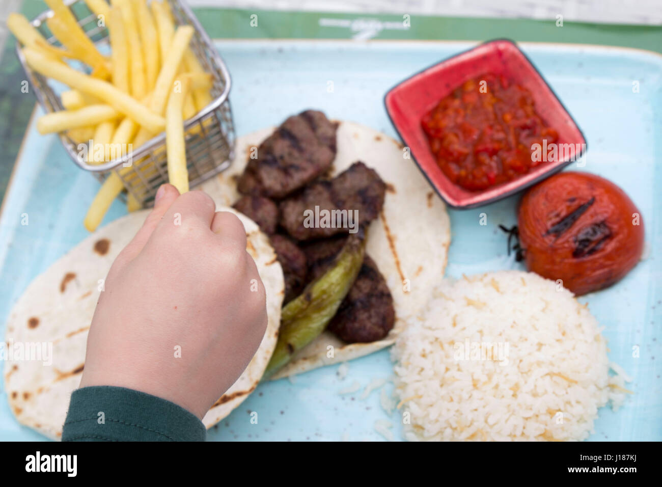 Hand taking fries hi-res stock photography and images - Alamy