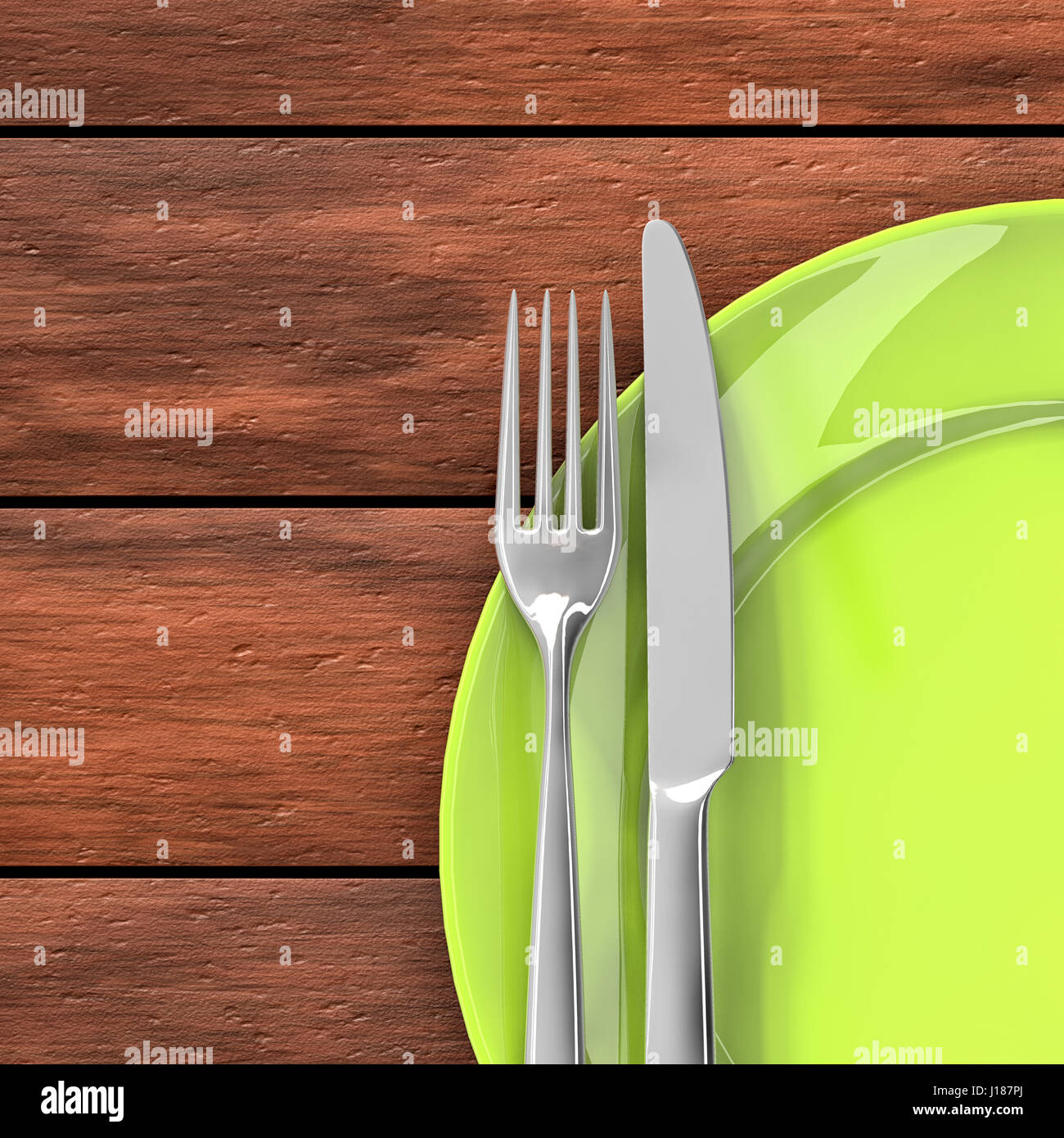 Knife, fork and green dish on the dining table Stock Photo - Alamy